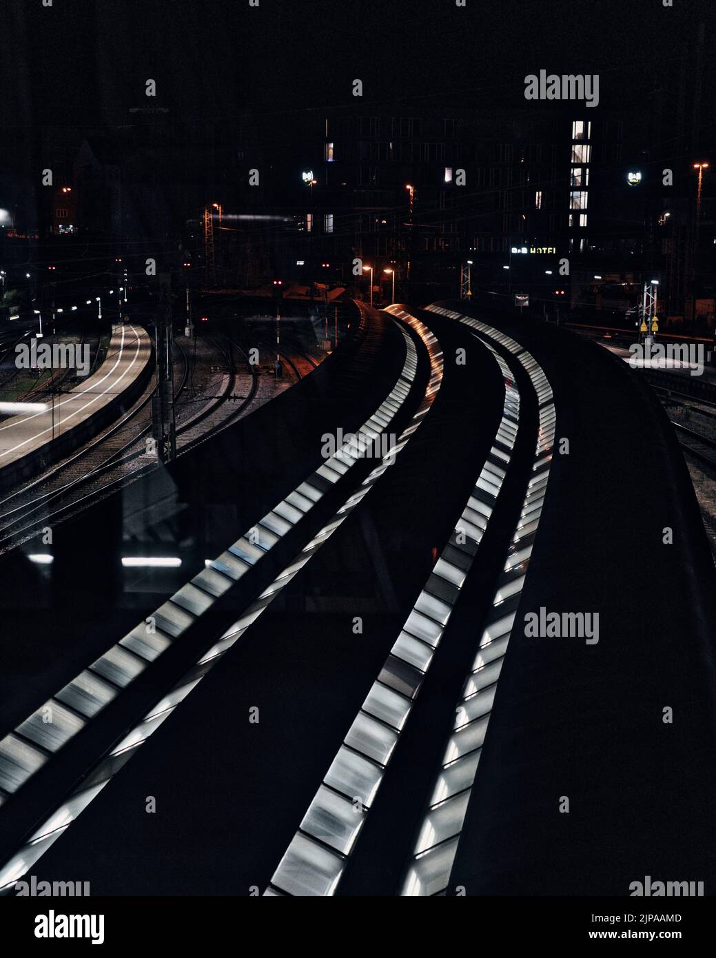 A railway with lights during nighttime Stock Photo - Alamy