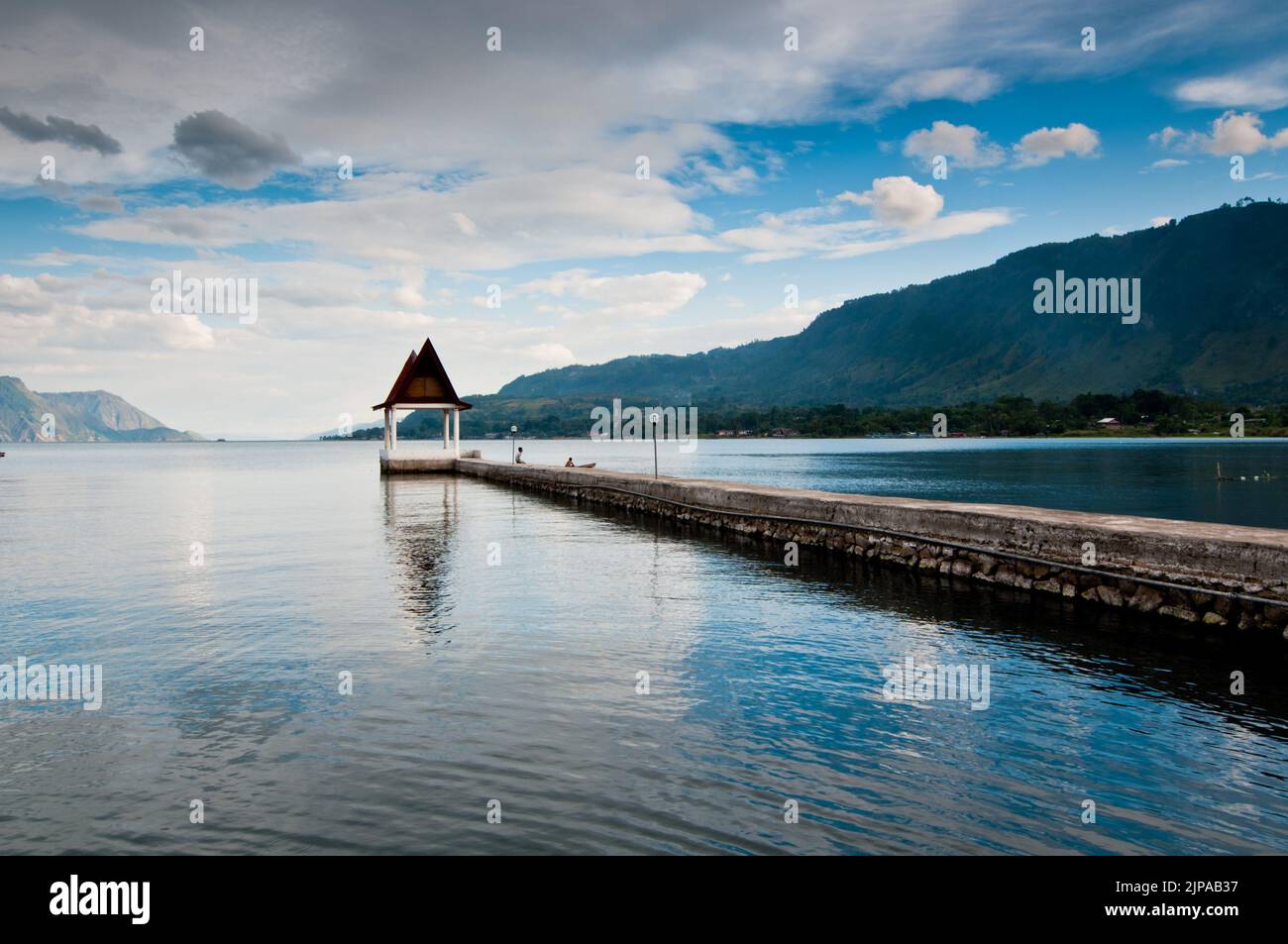 A scenic view of a pier with mountains in the background on Samosir ...