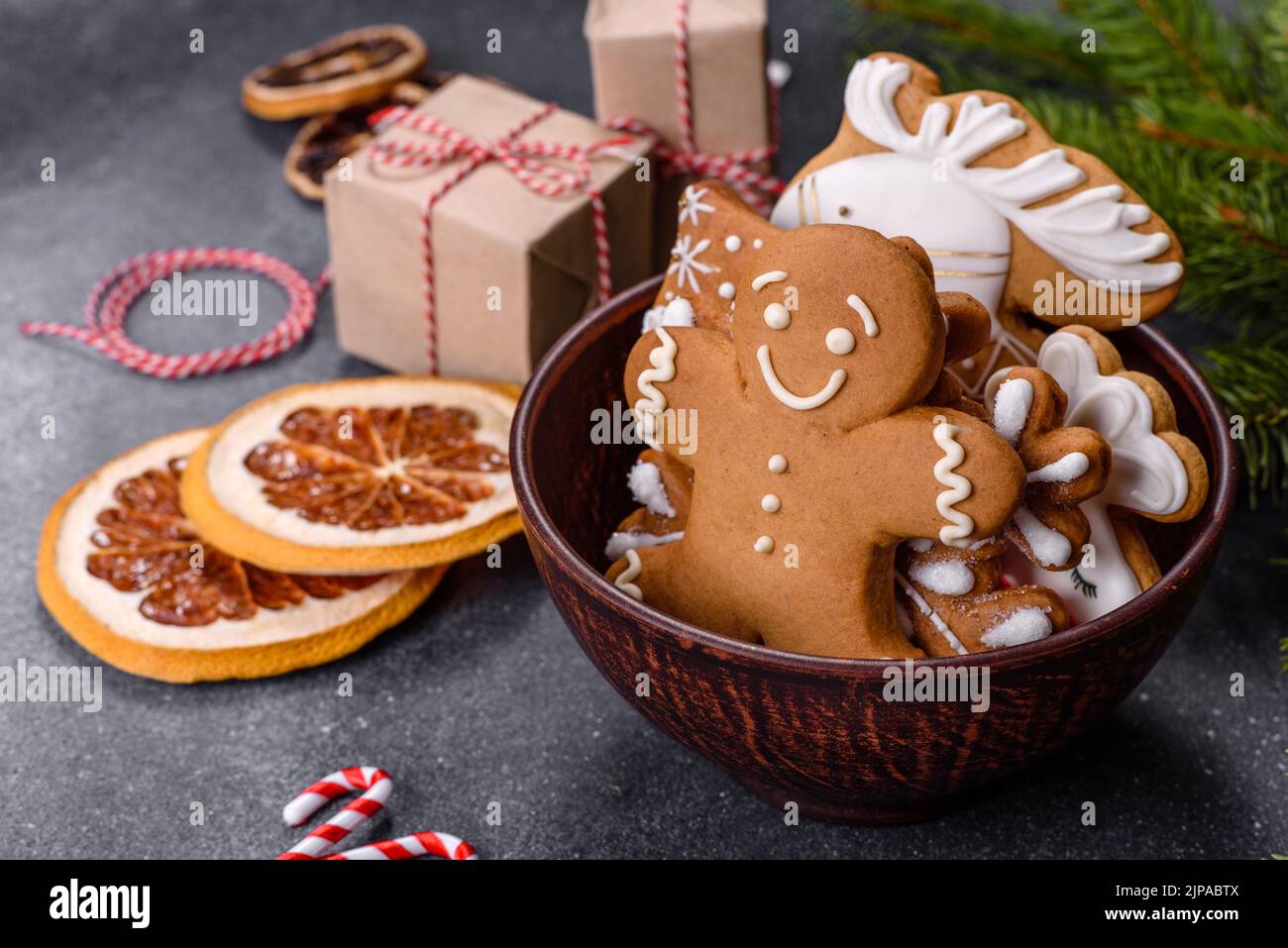 Gingerbread, Christmas tree decorations, dried citrus fruits on a gray ...