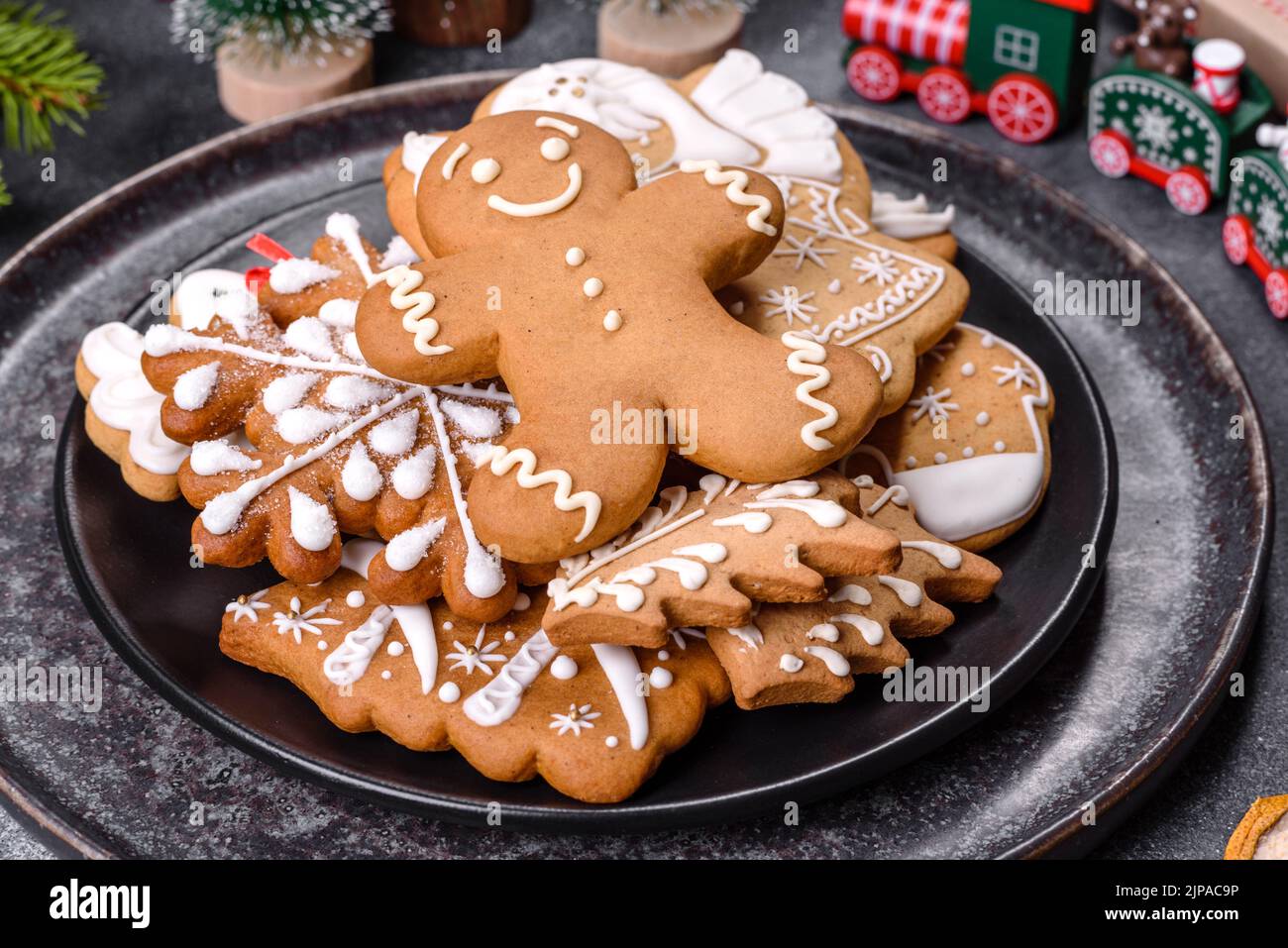 Gingerbread, Christmas tree decorations, dried citrus fruits on a gray ...
