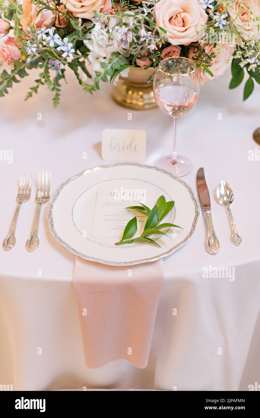 A vertical closeup shot of a wedding-styled table reception with ...