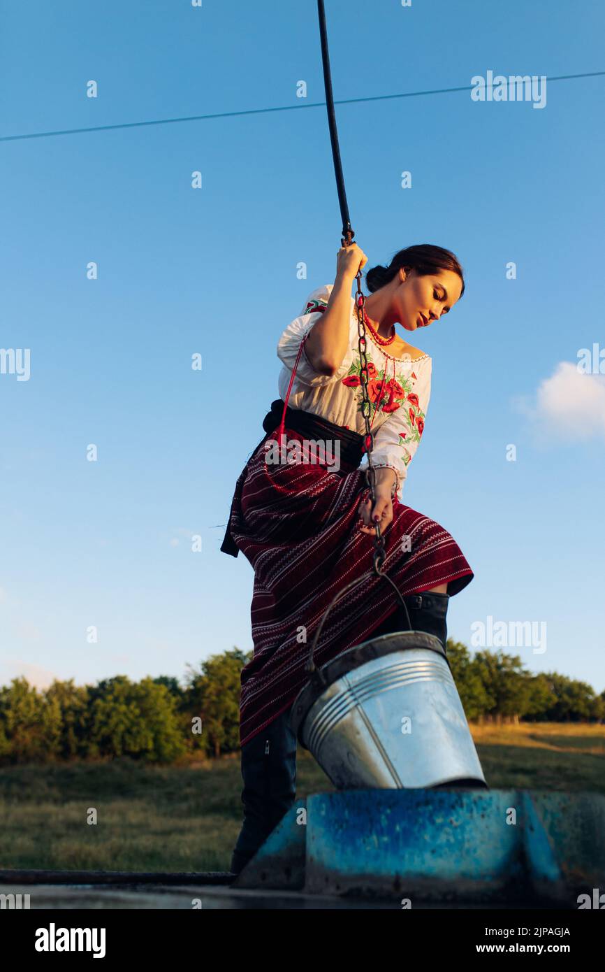 Young Ukrainian woman stands in traditional national embroidered shirt ...