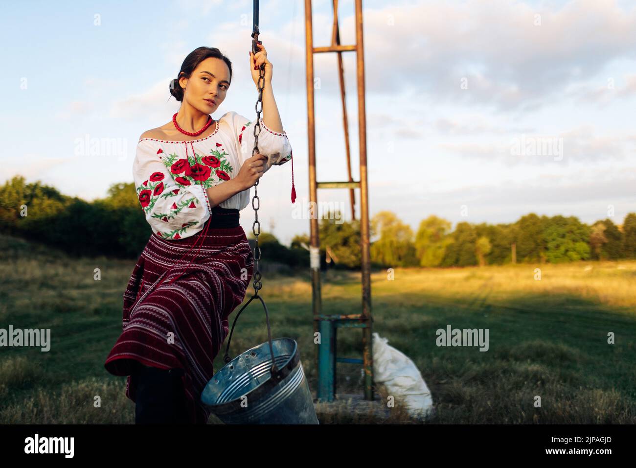 Young Ukrainian woman stands in traditional national embroidered shirt ...
