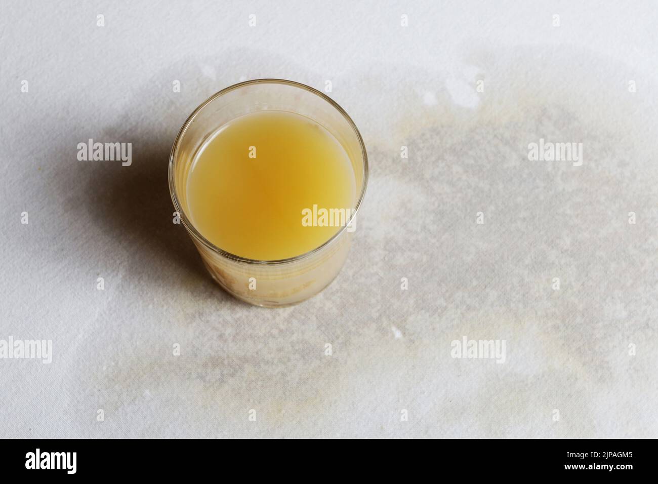 Orange juice spilled on the tablecloth. Large stain difficult to wash ...