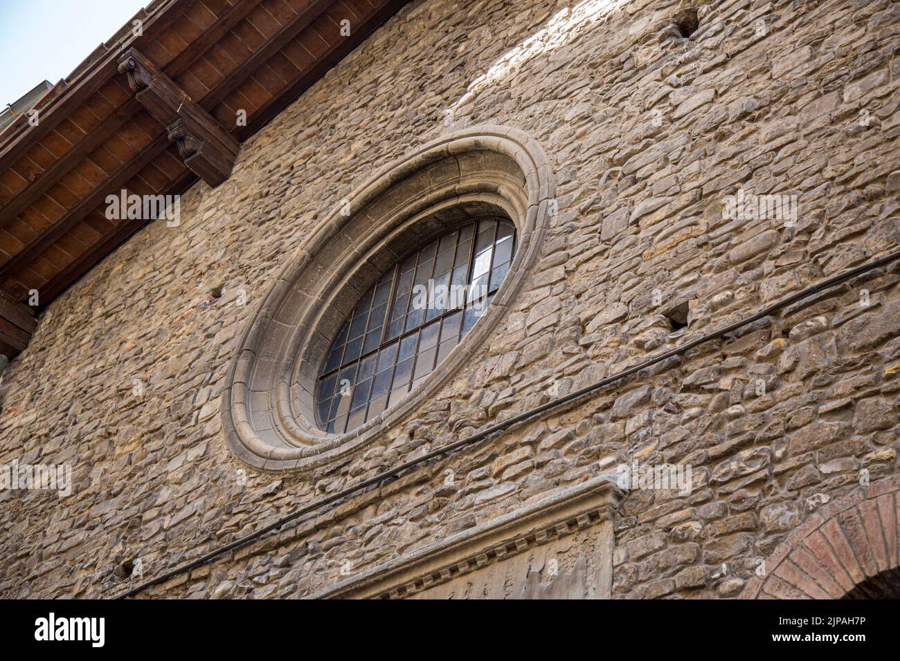 Large vintage round window with bars. Decorative element of an old ...