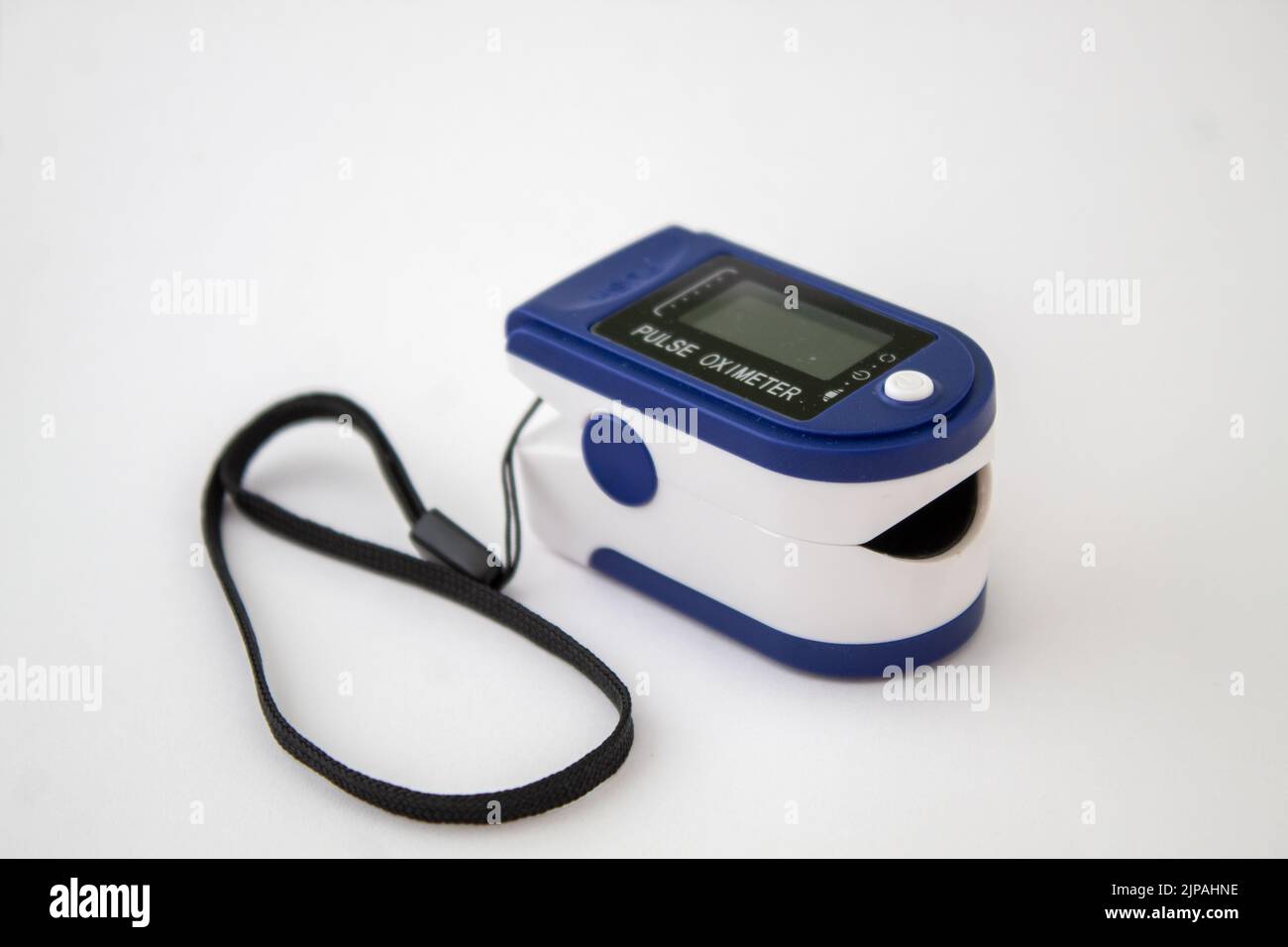 A blue pulse oximeter on the isolated white background Stock Photo - Alamy