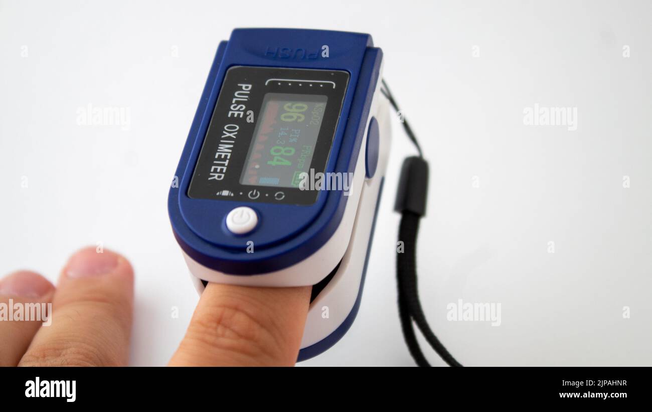 A blue pulse oximeter on the isolated white background Stock Photo - Alamy