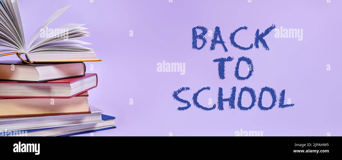 Close-up of a stack of books with one open book on top Stock Photo - Alamy