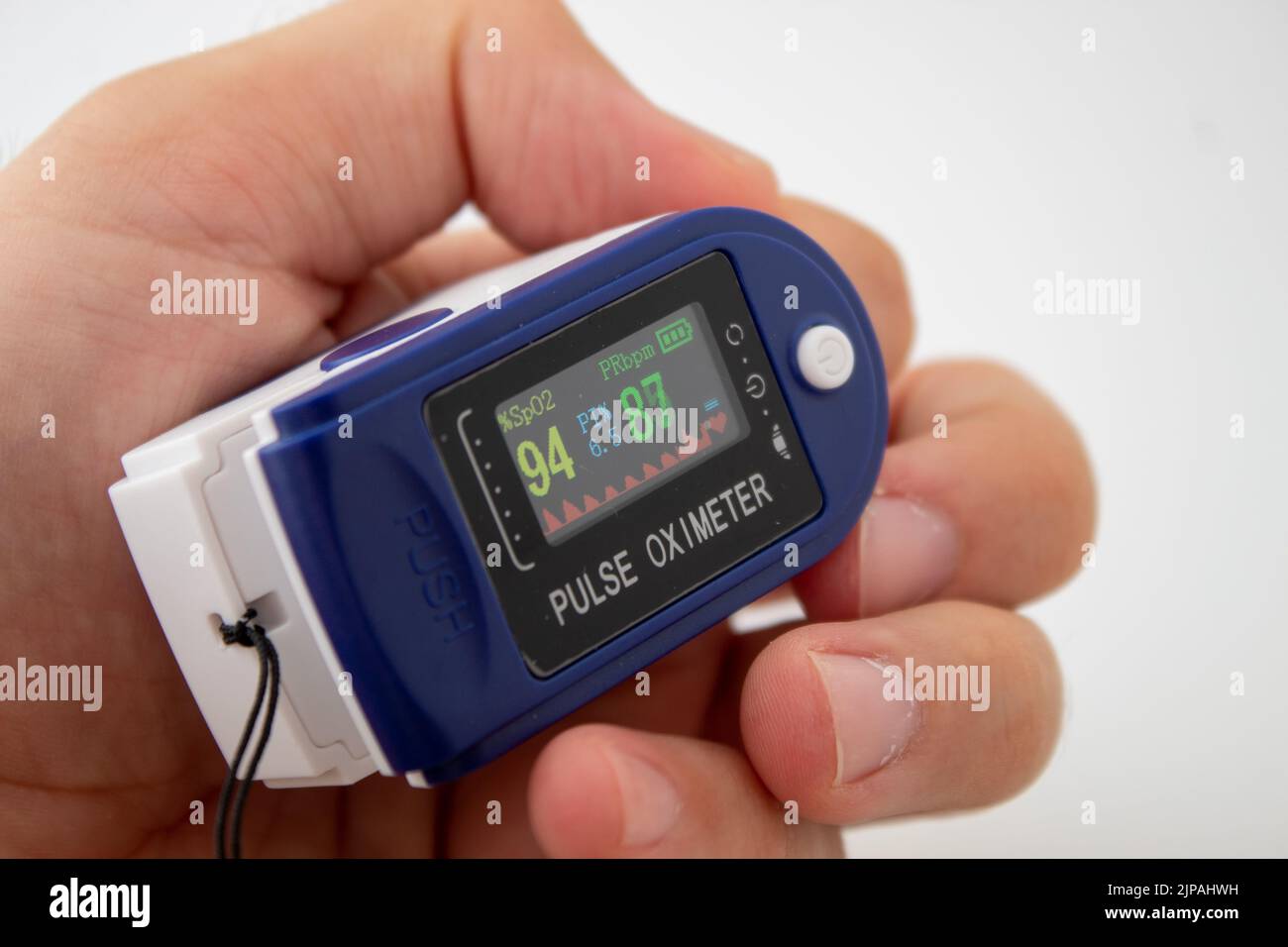 A blue pulse oximeter on the isolated white background Stock Photo - Alamy