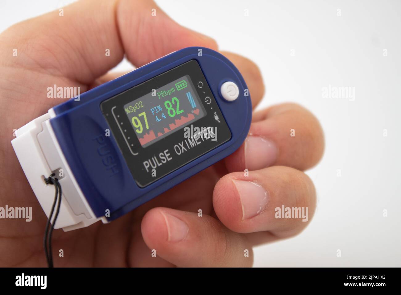 A blue pulse oximeter on the isolated white background Stock Photo - Alamy