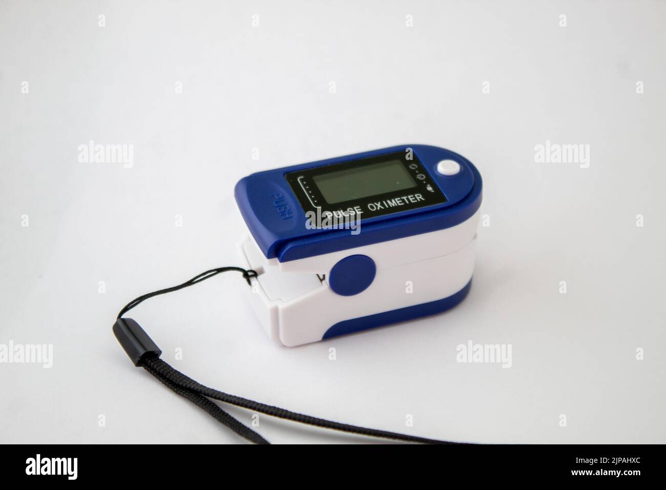A blue pulse oximeter on the isolated white background Stock Photo - Alamy