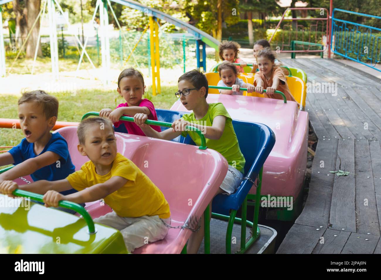 The happy little children are resting in the amusement park Stock Photo ...
