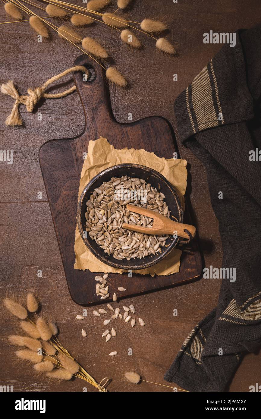 Sunflower seeds in a ceramic bowl on a rustic kitchen countertop Stock ...