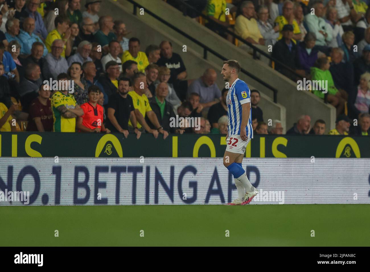 Tom Lees #32 of Huddersfield Town walks off the pitch after being shown ...