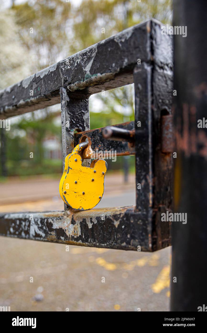 Yellow Padlock on the barrier post in a restricted area Stock Photo - Alamy