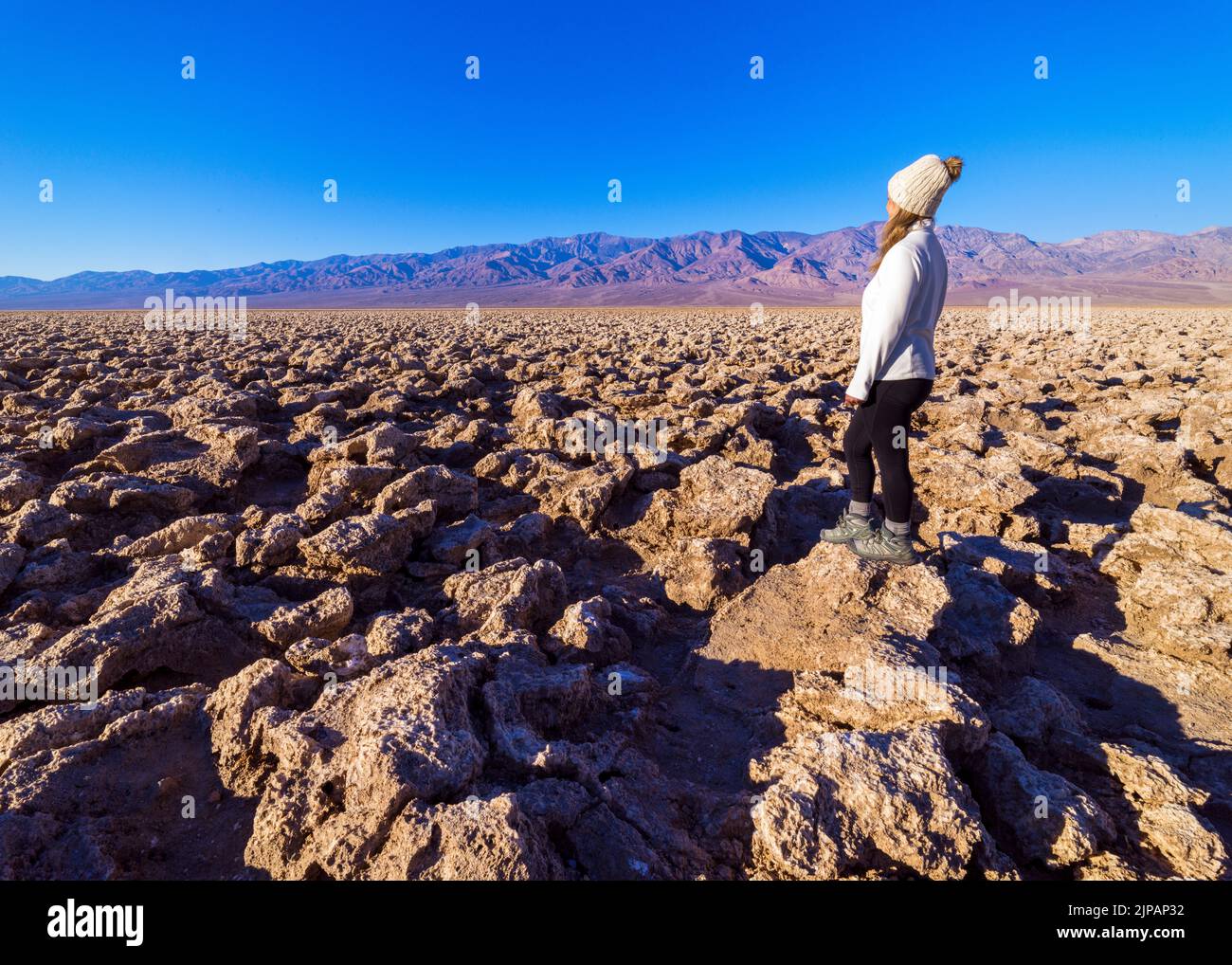 Hiker enjoying Devils Golf Course Bad Water Basin, Salt Flats,Salt ...