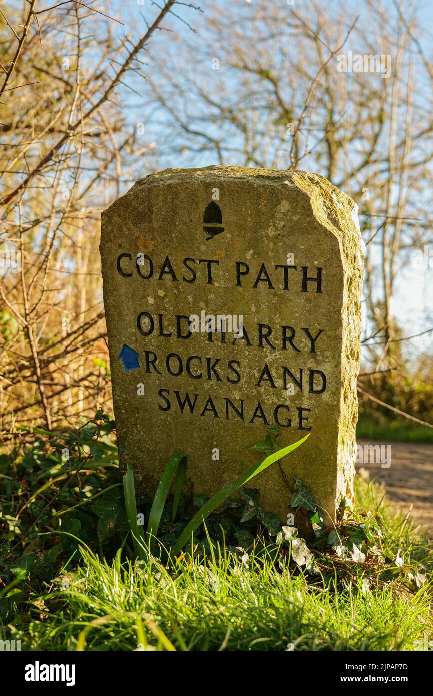 A closeup shot of a coast path with a sign leading to Old Harry Rocks ...