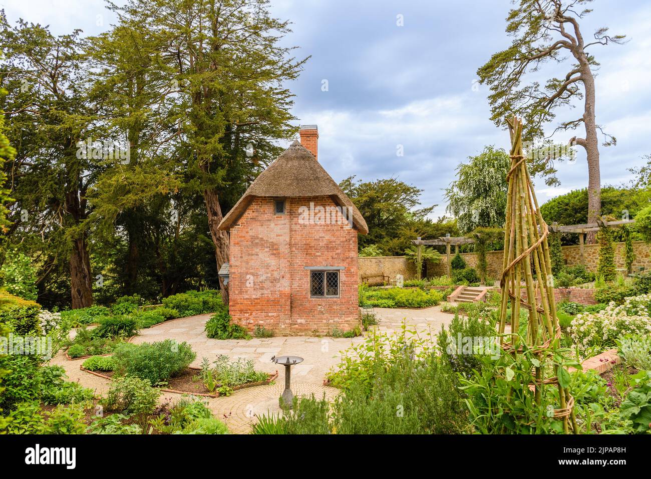 A beautiful view of a small brick hut surrounded by trees and ...