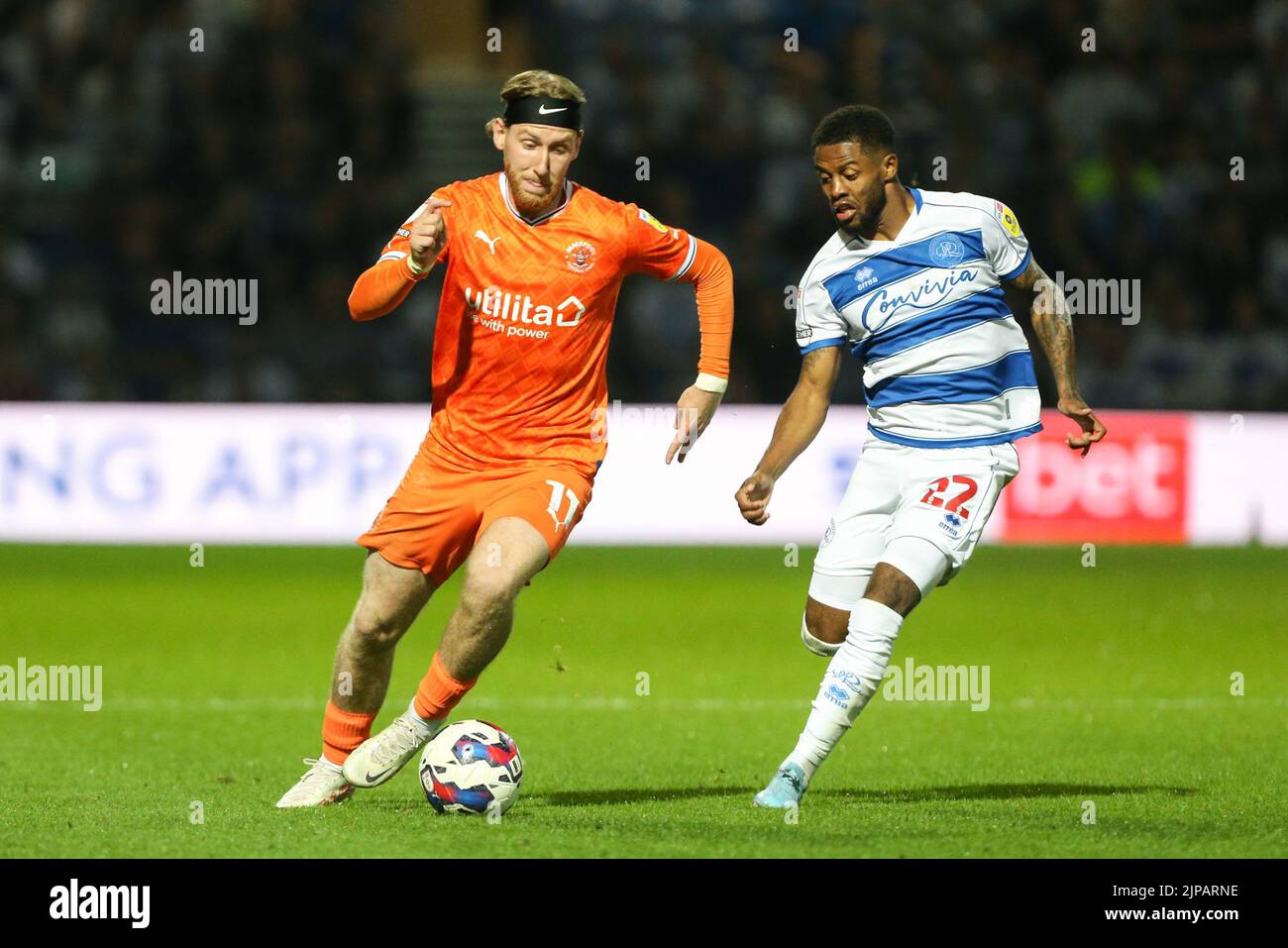Josh Bowler #11 of Blackpool runs at Kenneth Paal #22 of QPR Stock ...