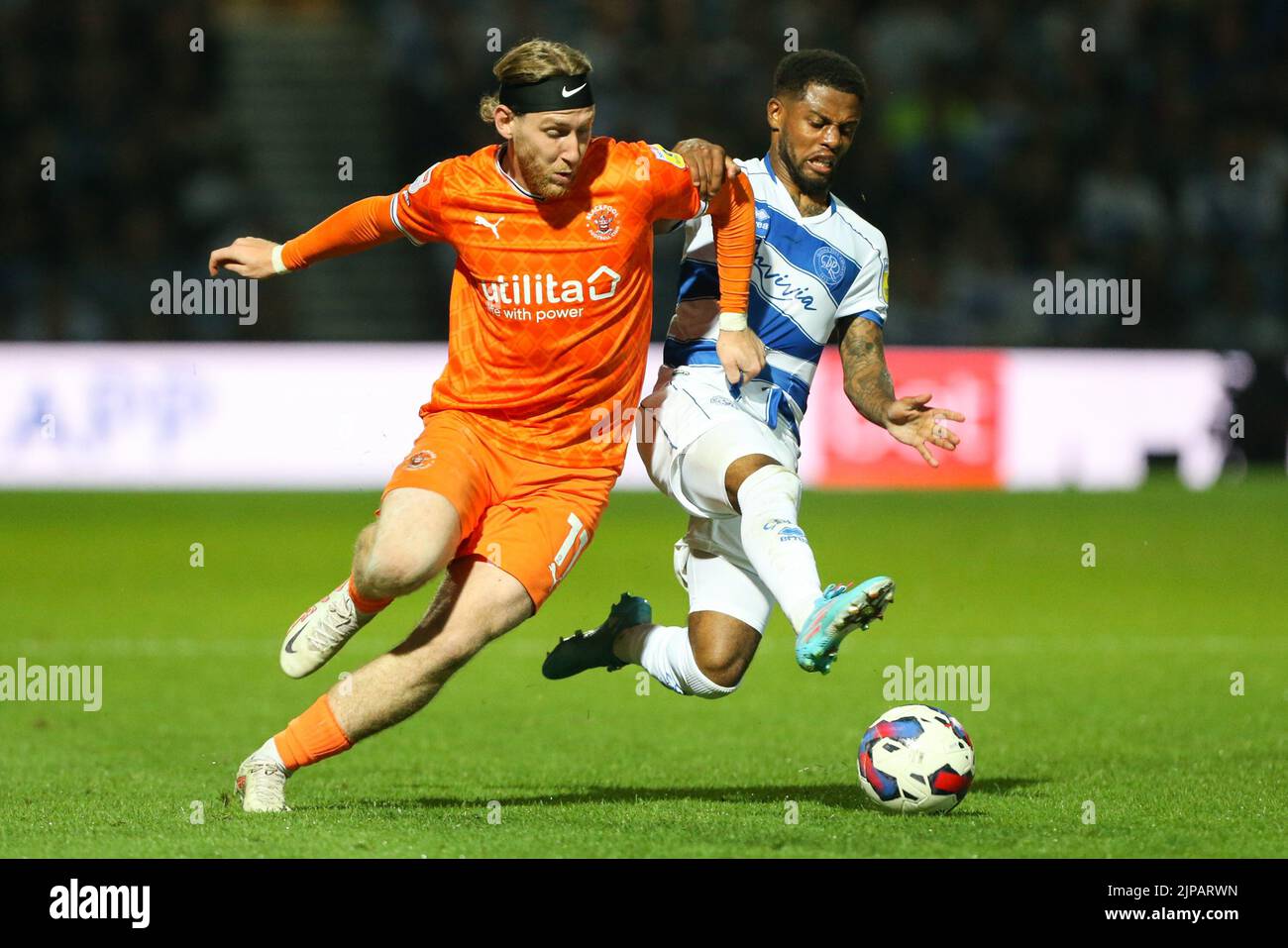 Josh Bowler #11 of Blackpool and Kenneth Paal #22 of QPR tussle for the ...