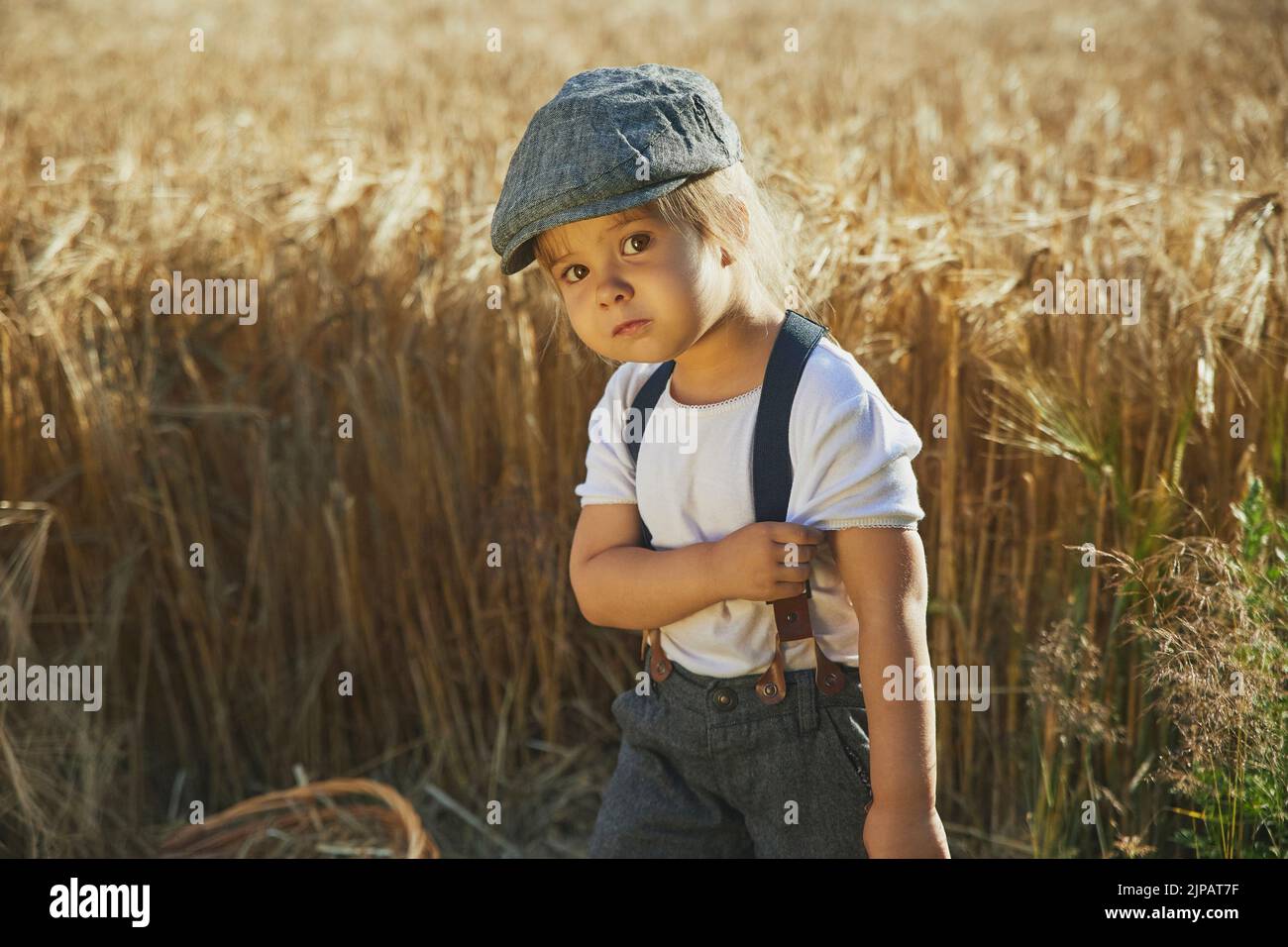 Adorable sad street child in a field Stock Photo - Alamy