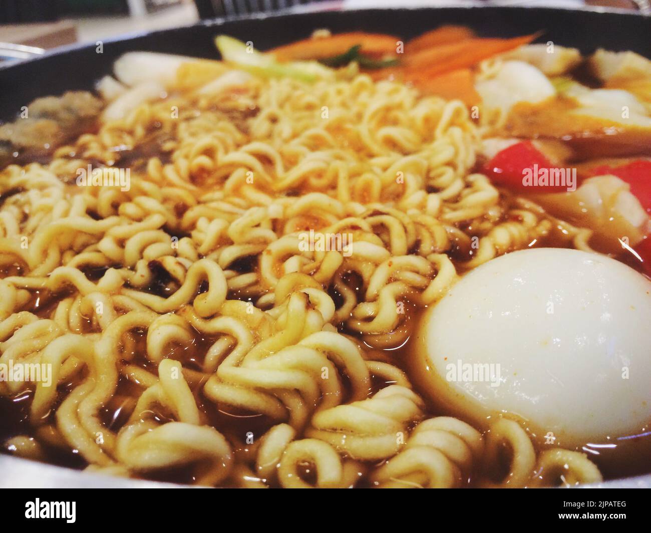 Close up image of Korean spicy instant noodle, Ramyun, with egg yolk ...