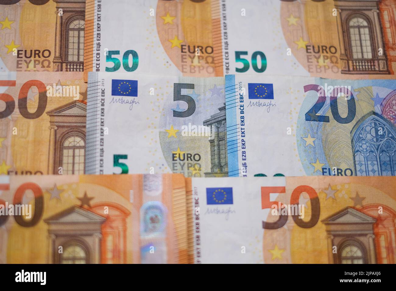 The background consists of many euro banknotes of different ...