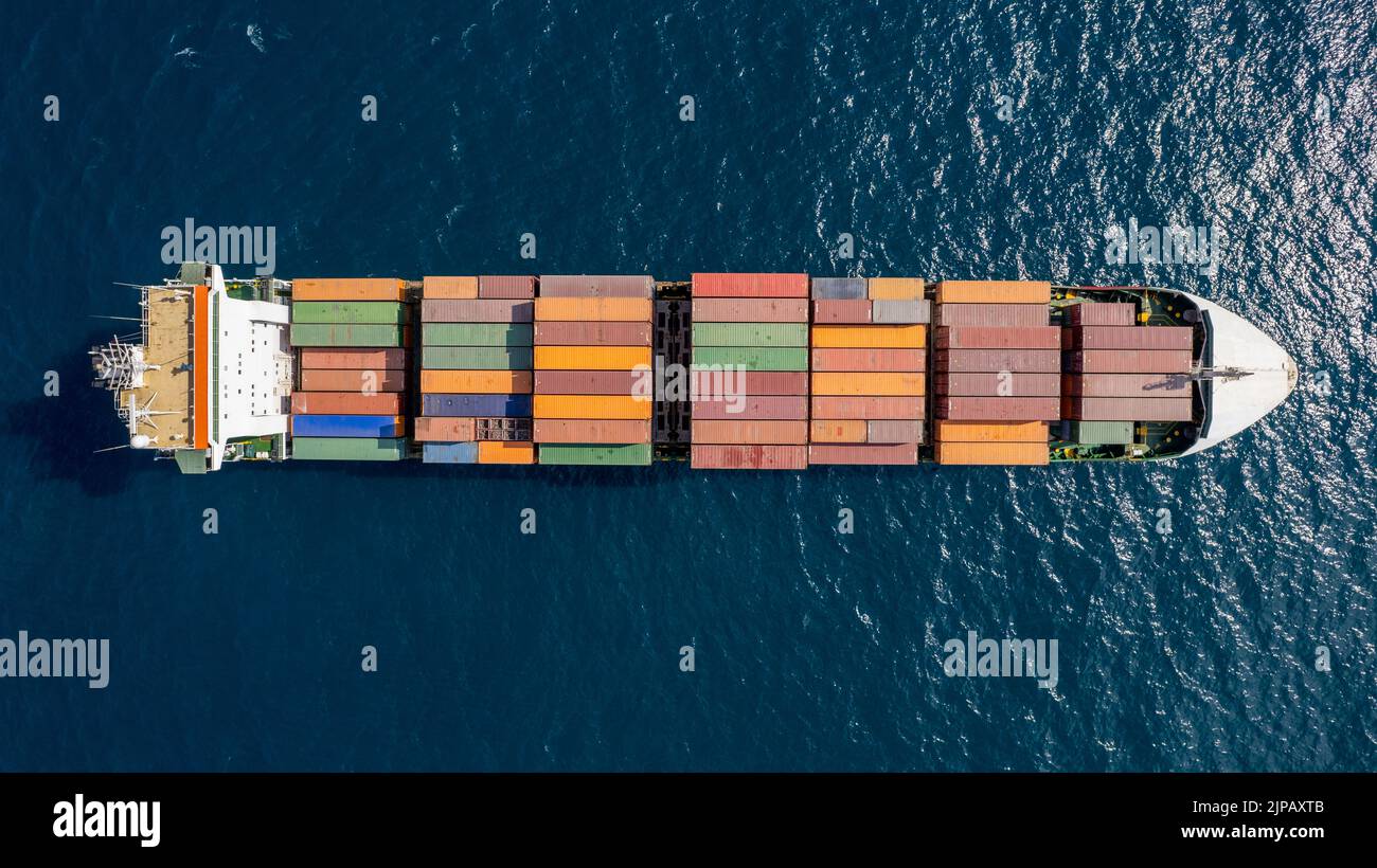 Drone top view of fully loaded container ship cruising open ocean sea ...