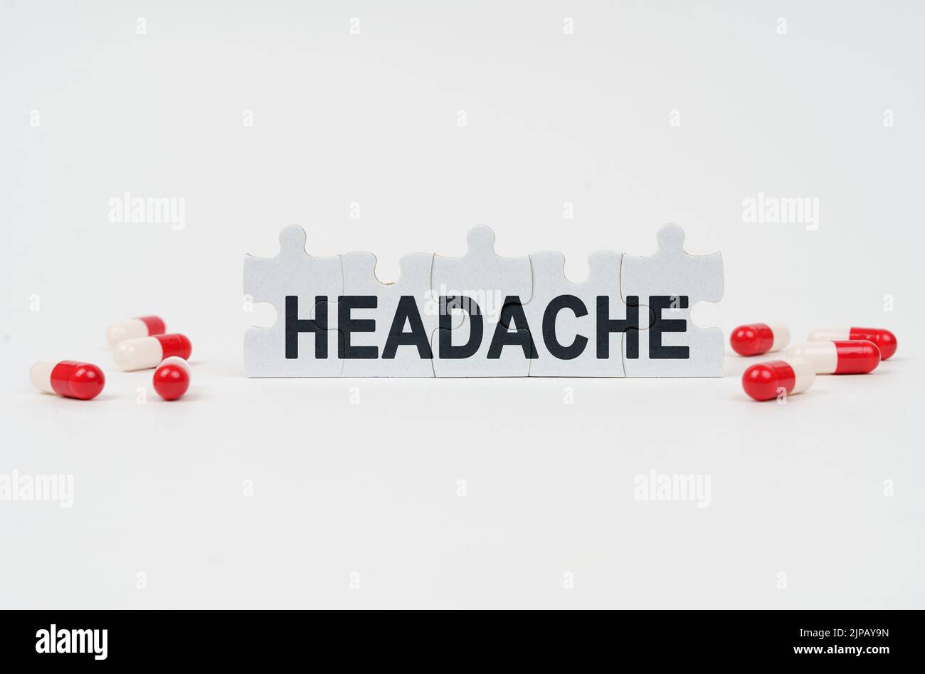 Medical concept. On a white surface are tablets and puzzles with the ...