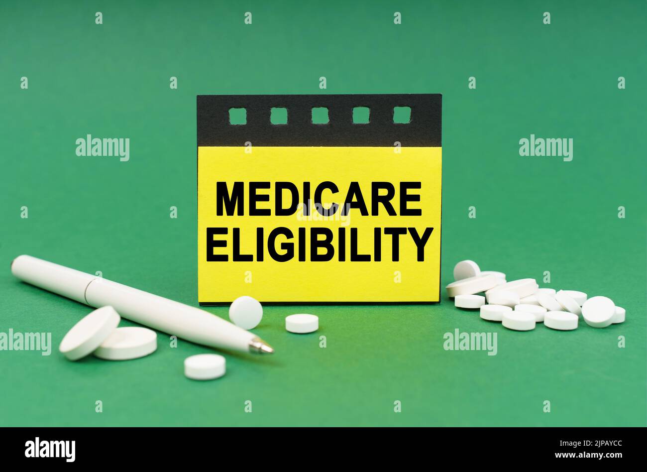 Medical concept. On the green surface are tablets, a pen and stickers ...