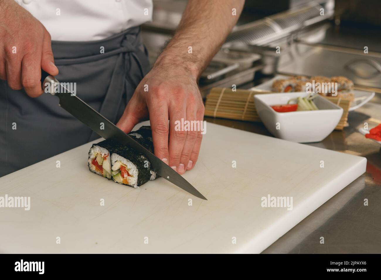 Close up of man japanese restaurant chef cooking sushi in the kitchen ...