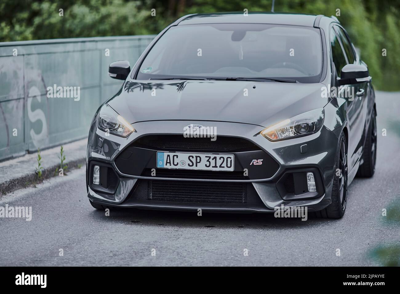 A gray Rallye Sport Ford car driving out of a parking lot Stock Photo ...