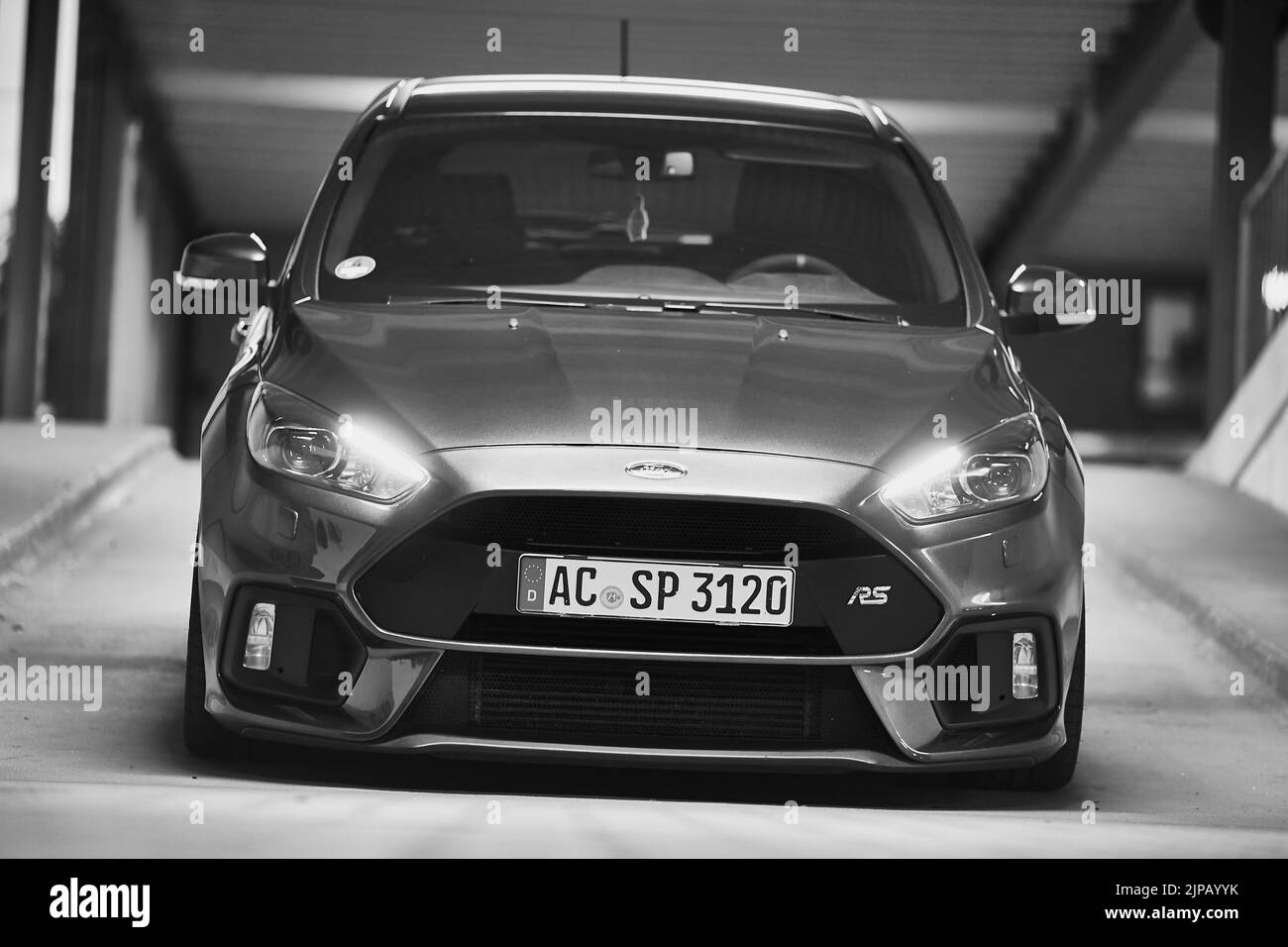 A gray Rallye Sport Ford car driving out of a parking lot Stock Photo ...
