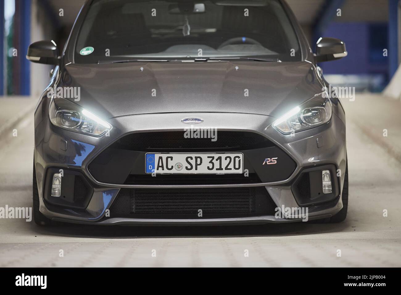 A gray Rallye Sport Ford car driving out of a parking lot Stock Photo ...