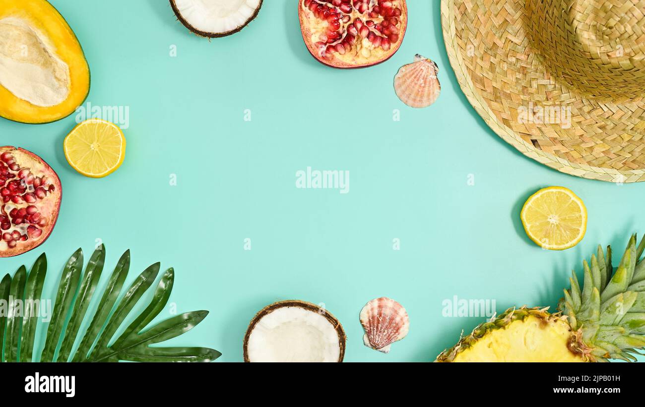 Summer tropic frame made with exotic fruits on pastel tirquoise ...