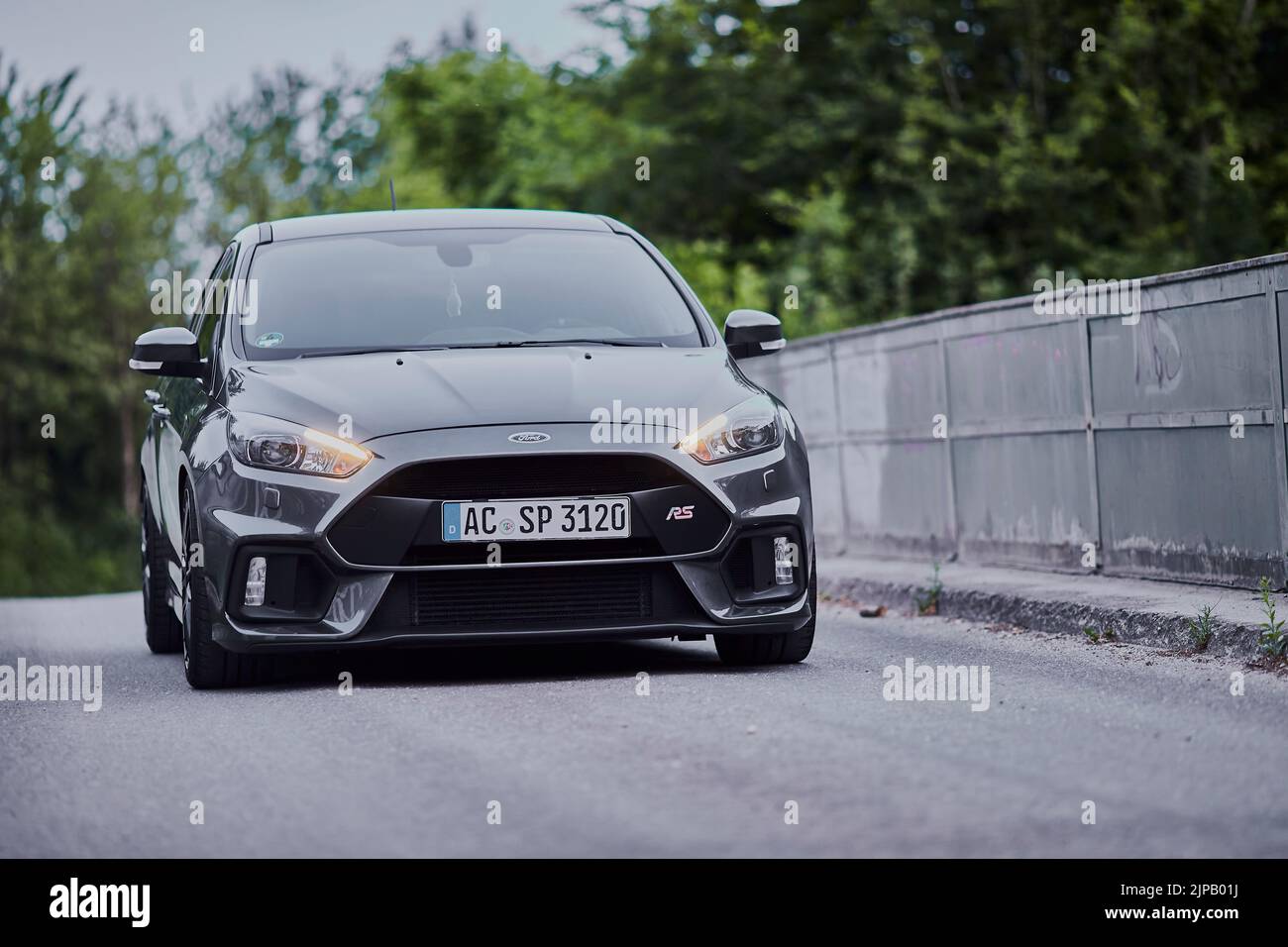 A gray Rallye Sport Ford car driving out of a parking lot Stock Photo ...