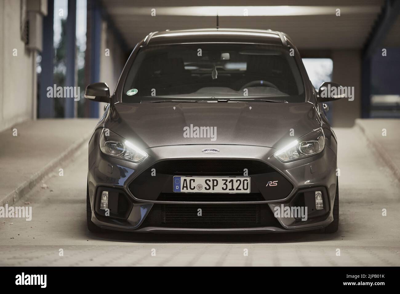A gray Rallye Sport Ford car driving out of a parking lot Stock Photo ...
