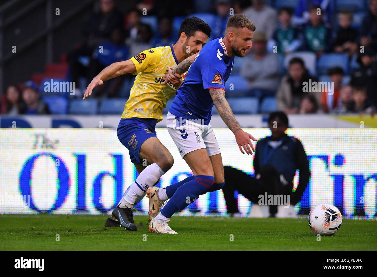 Oldham, UK. 16th Aug, 2022. Jack Stobbs of Oldham Athletic tussles with ...