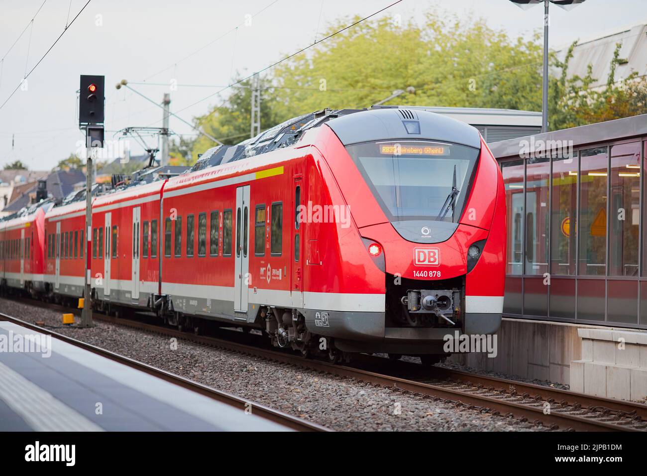 A red DB train arriving at a station in Geilenkirchen, Germany Stock ...