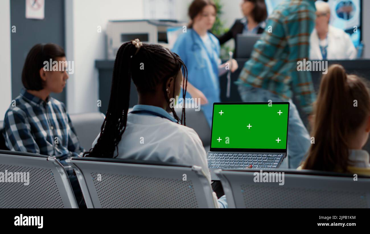 African american physician working with greenscreen on laptop computer ...