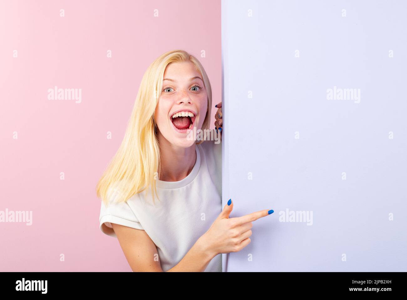 Woman pointing finger on blank board. Woman standing behind the banner ...
