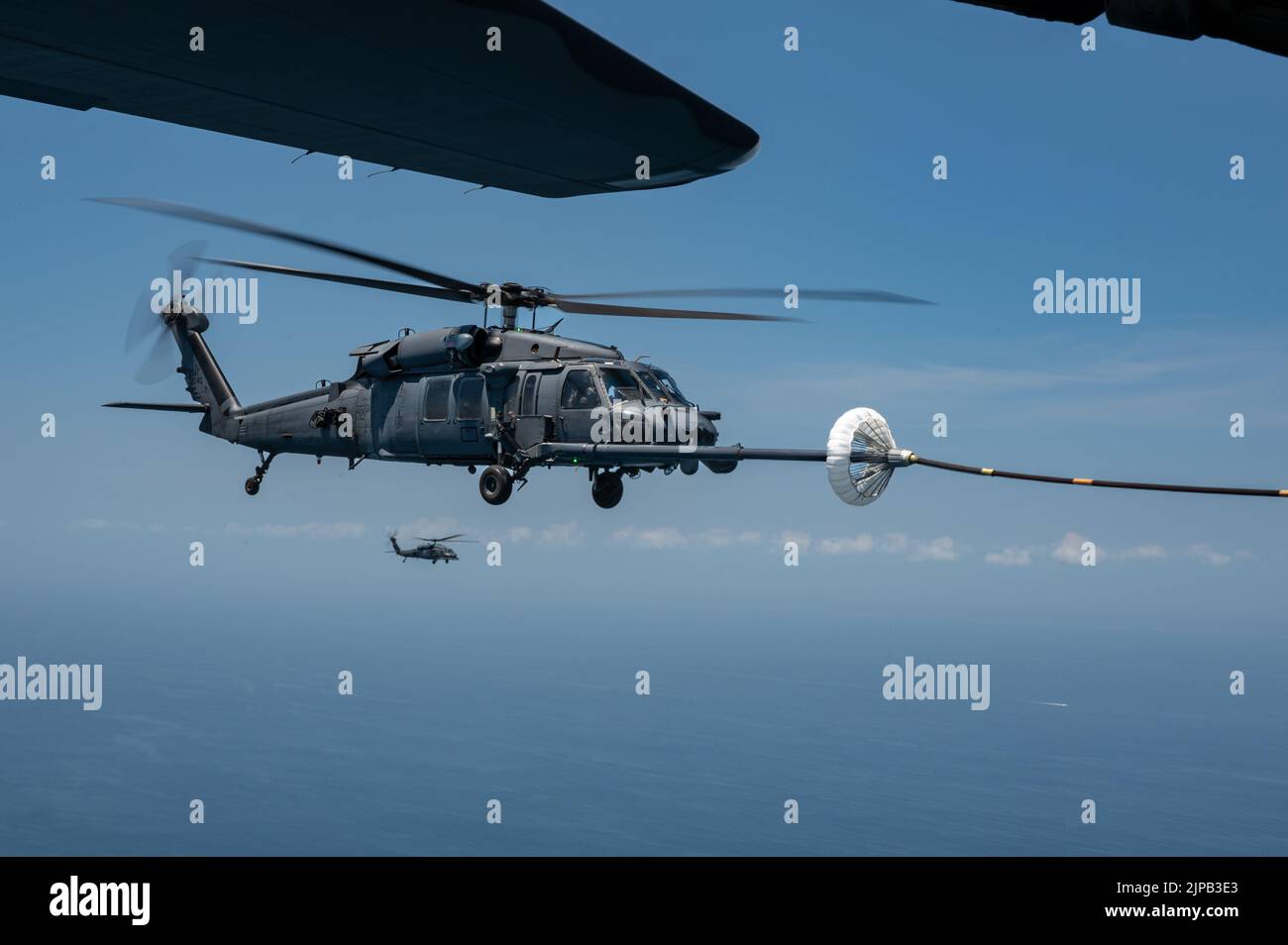 A HH-60G Pave Hawk Helicopter is refueled by a 39th Rescue Squadron HC ...