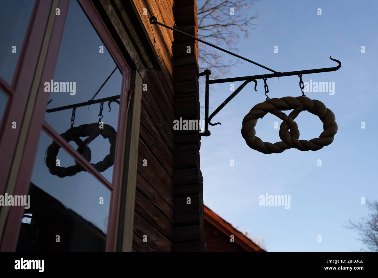 Pretzel reflected in windows of bakery in Skansen, Stockholm, Sweden ...