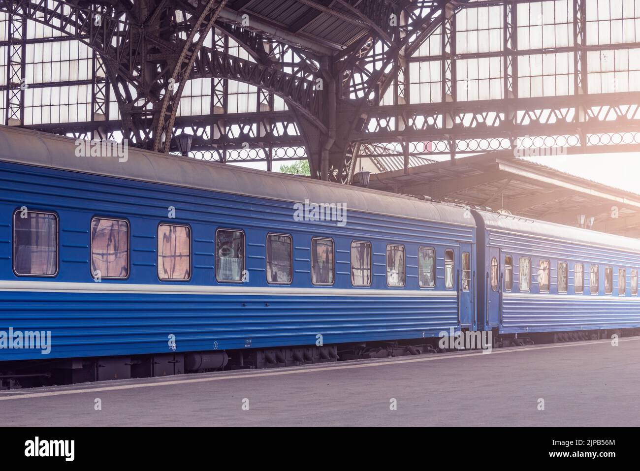 Train stands by the platform before departure at sunset Stock Photo - Alamy