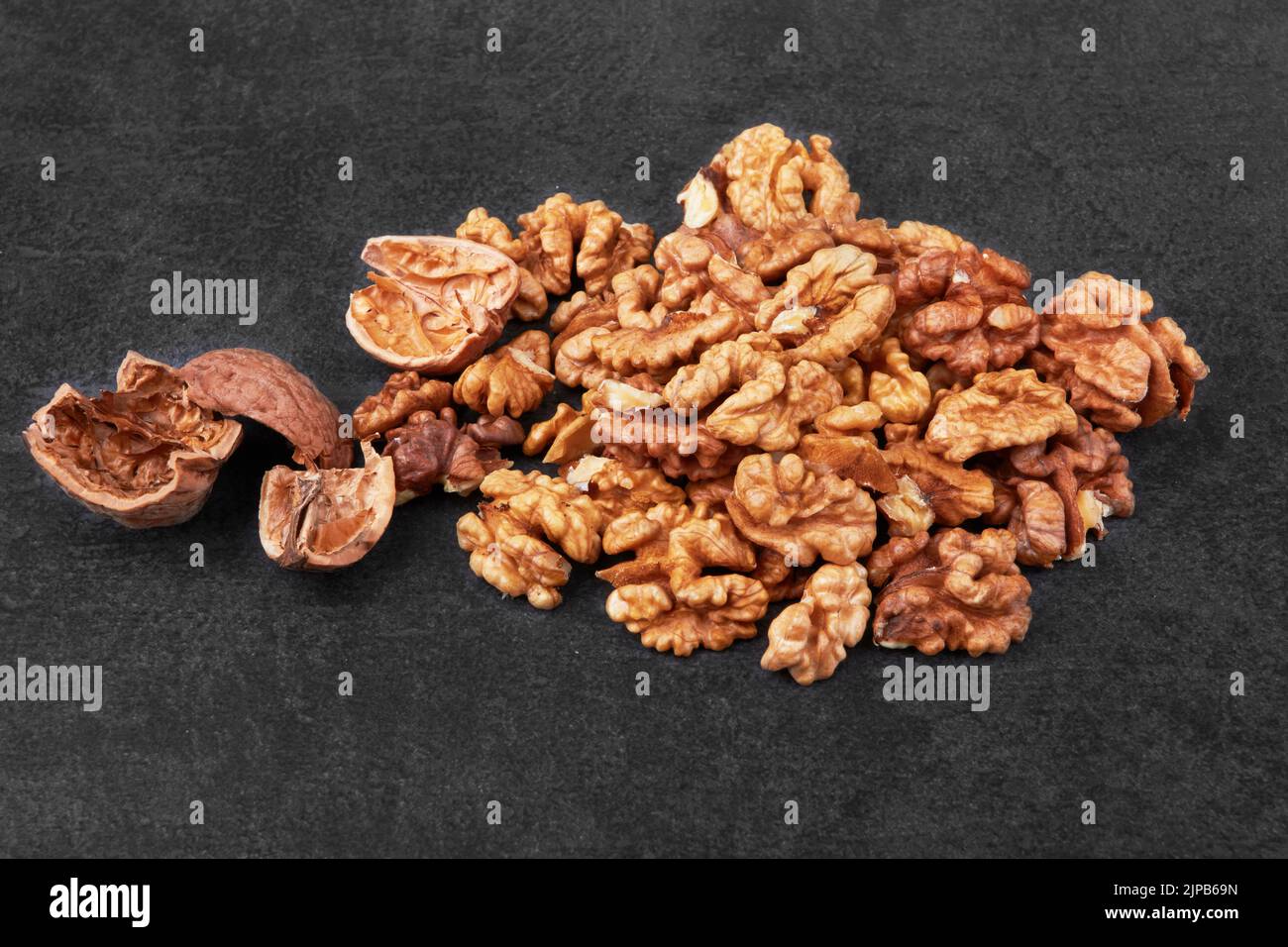 Pile of walnuts on a stone black surface Stock Photo - Alamy