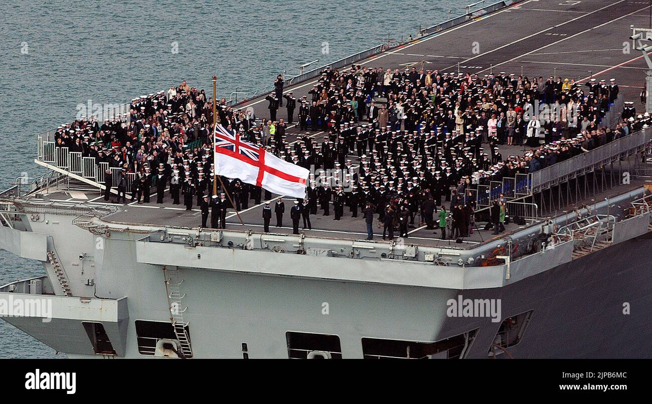 THE WHITE ENSIGN IS LOWERED WATCHED BY CREW AND GUESTS ABOARD THE ...
