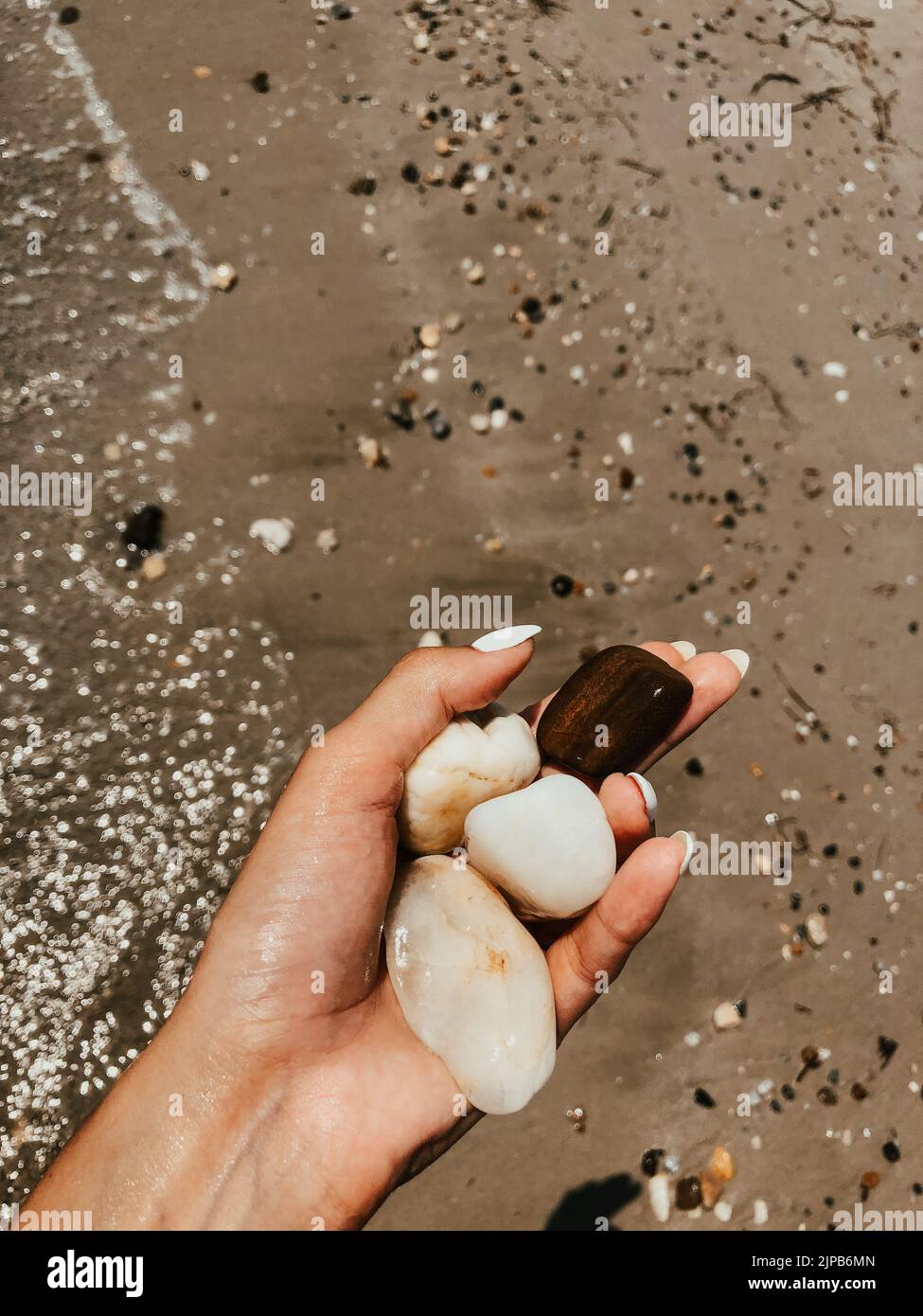 Hand holding pebbles hi-res stock photography and images - Alamy