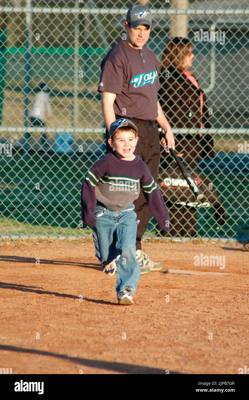 Youth and coaches on sports fields during spring sports, being coached ...