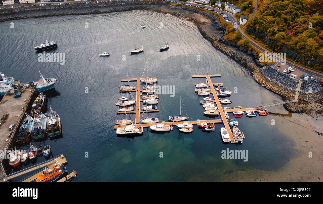 An aerial shot of Mallaig port in Highlands Scotland with boats and ...