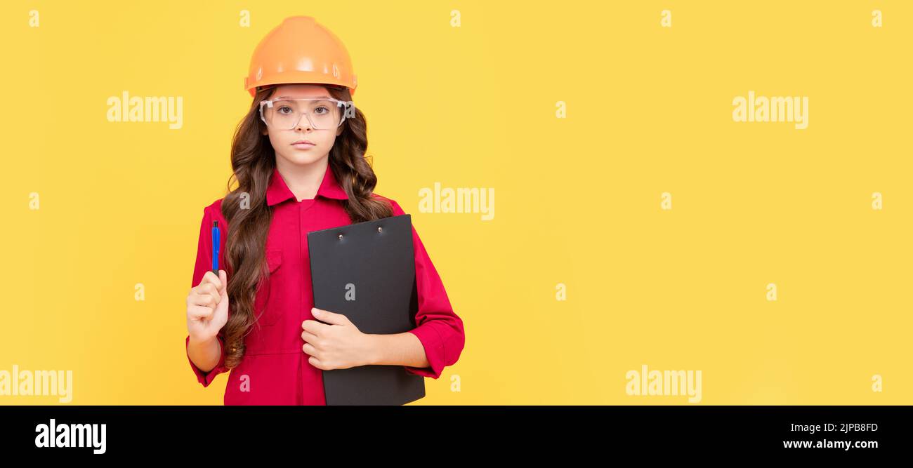 Builder teenager girl in helmet. serious child girl in protective hard ...